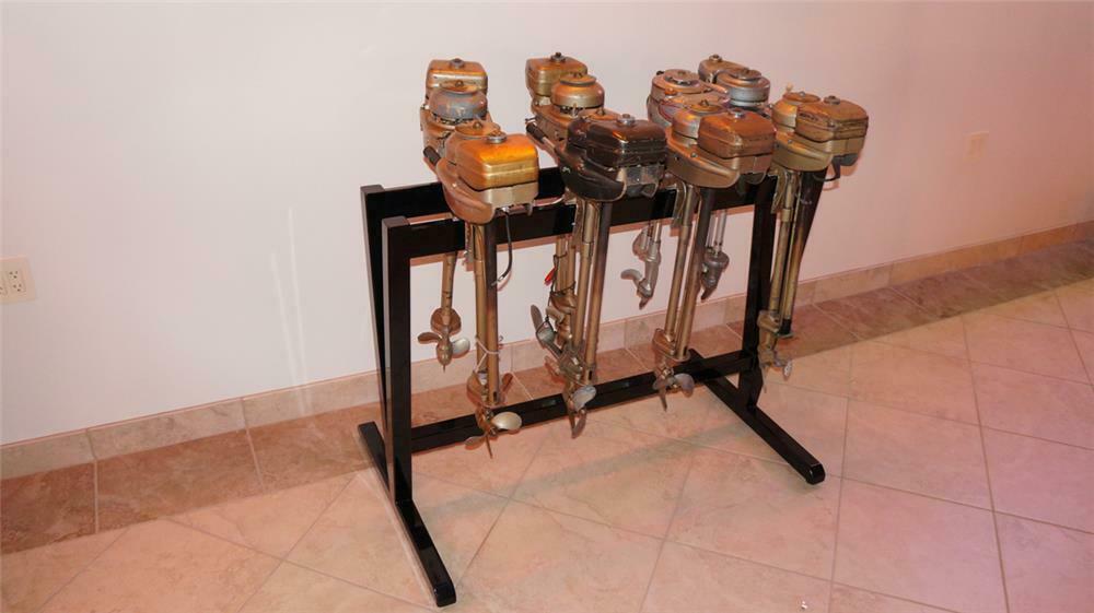 Display rack of eight 1930's outboard motors consisting of Ne