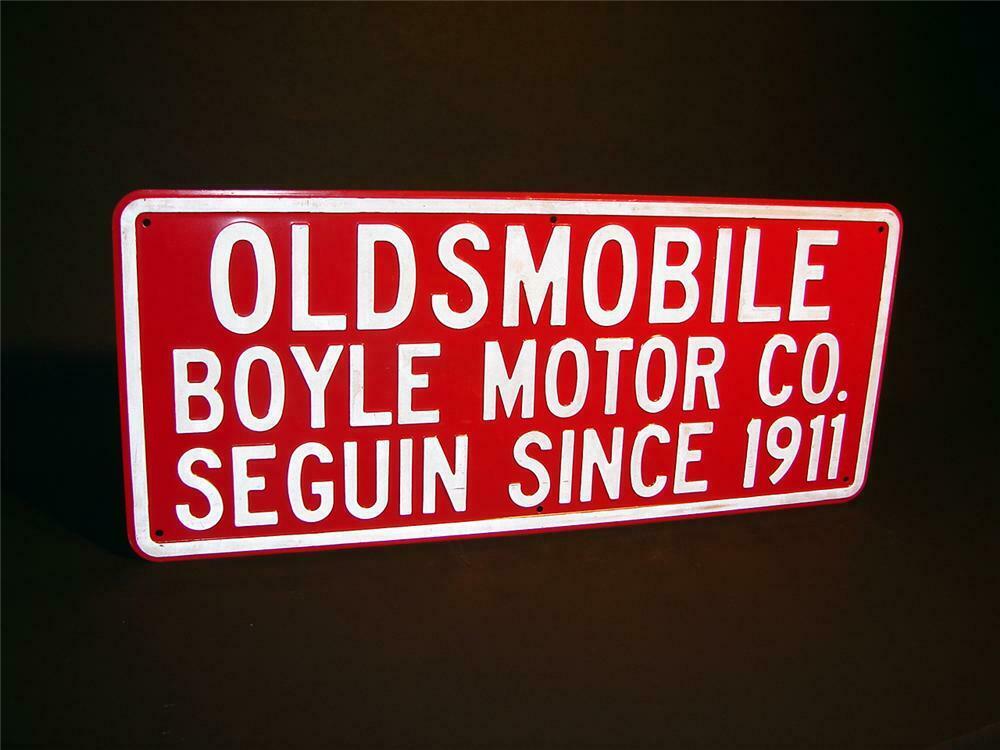 1940s Oldsmobile dealership tin sign with embossed lettering.