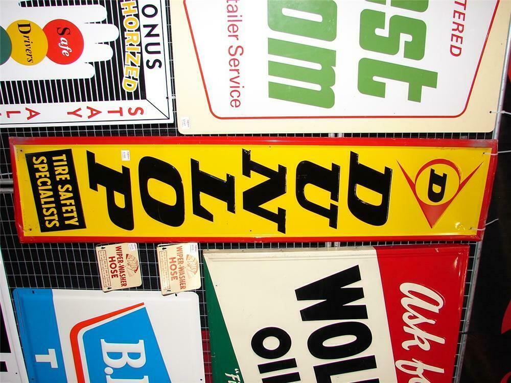 Dunlop Tires vertical tin embossed garage sign.